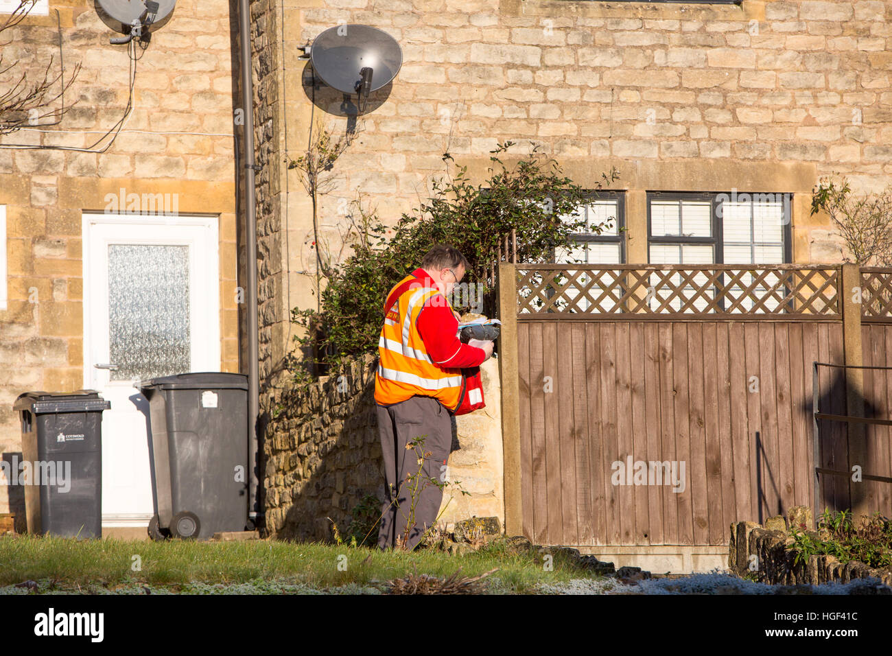 Royal mail postman delivering letters to homes in Chipping Campden ...