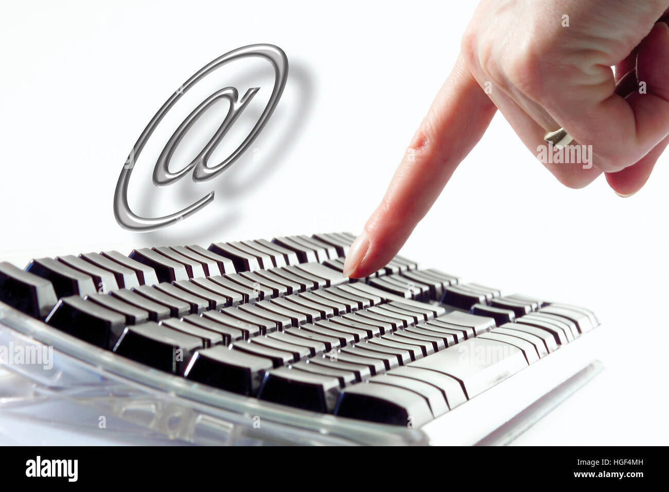 Keyboard and woman's hand, @ symbol Stock Photo - Alamy