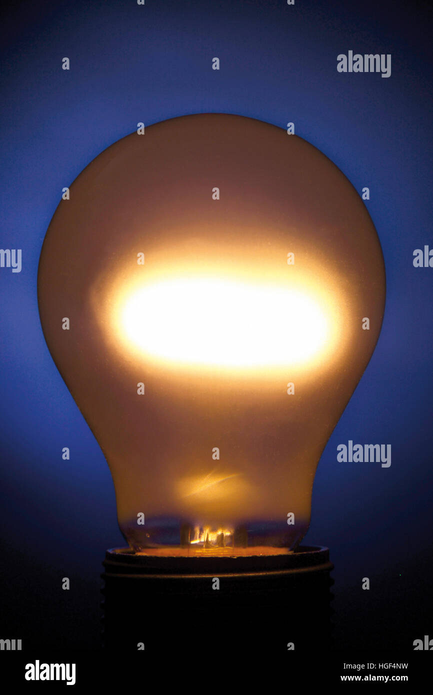 Glowing lightbulb, blue background Stock Photo - Alamy