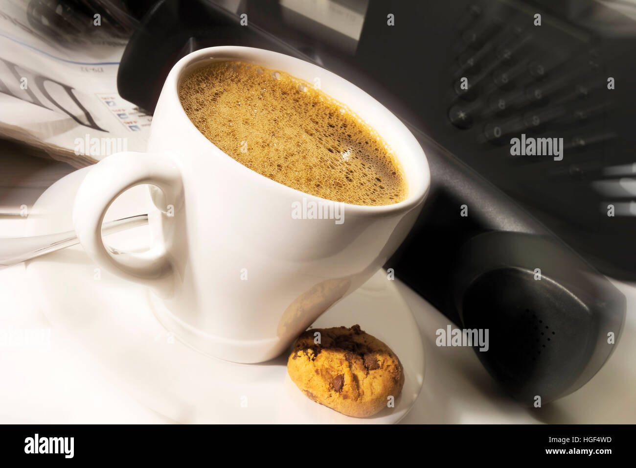 Cup of coffee, telephone in background Stock Photo - Alamy