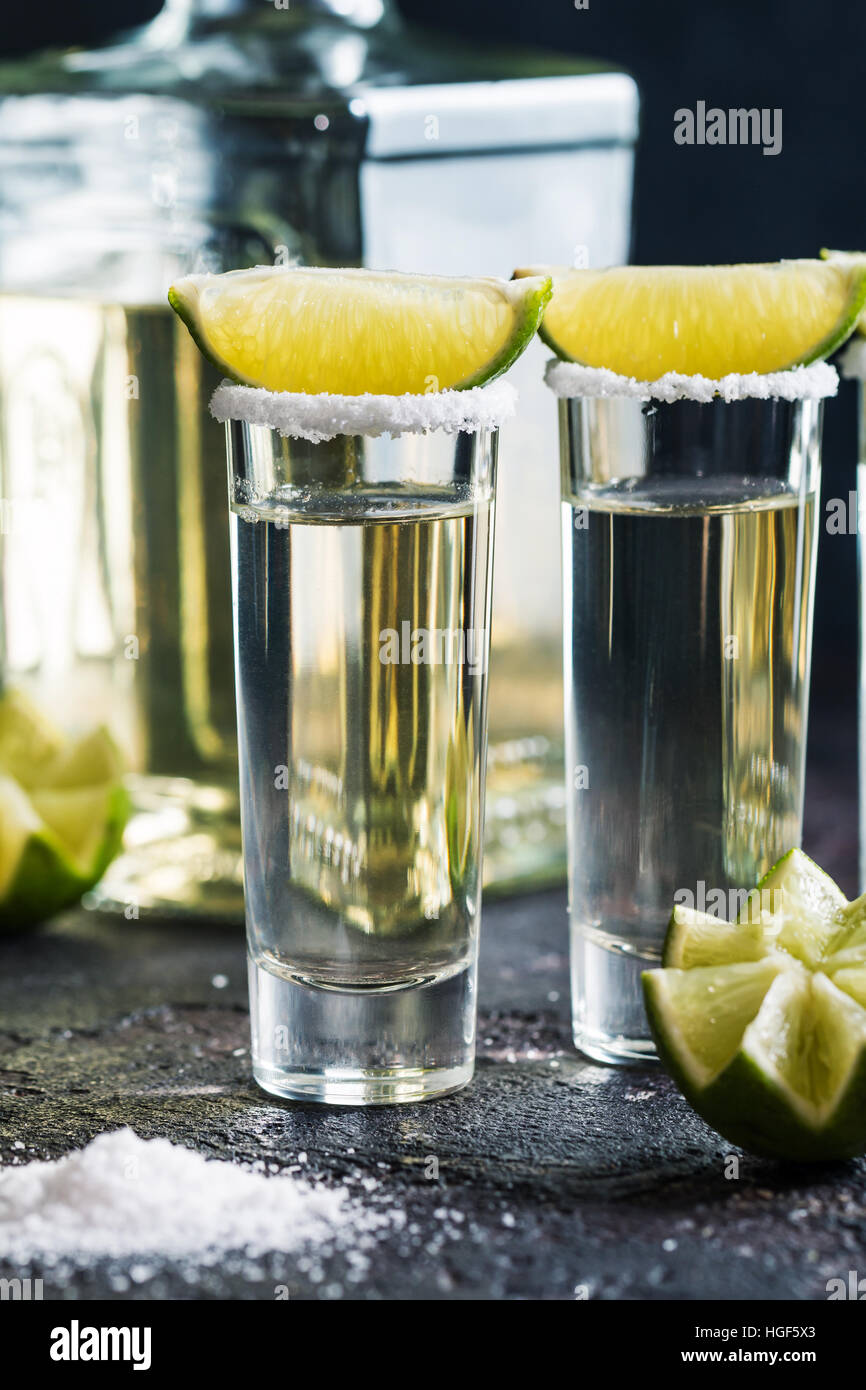 Mexican Gold Tequila with lime and salt on black background Stock Photo ...