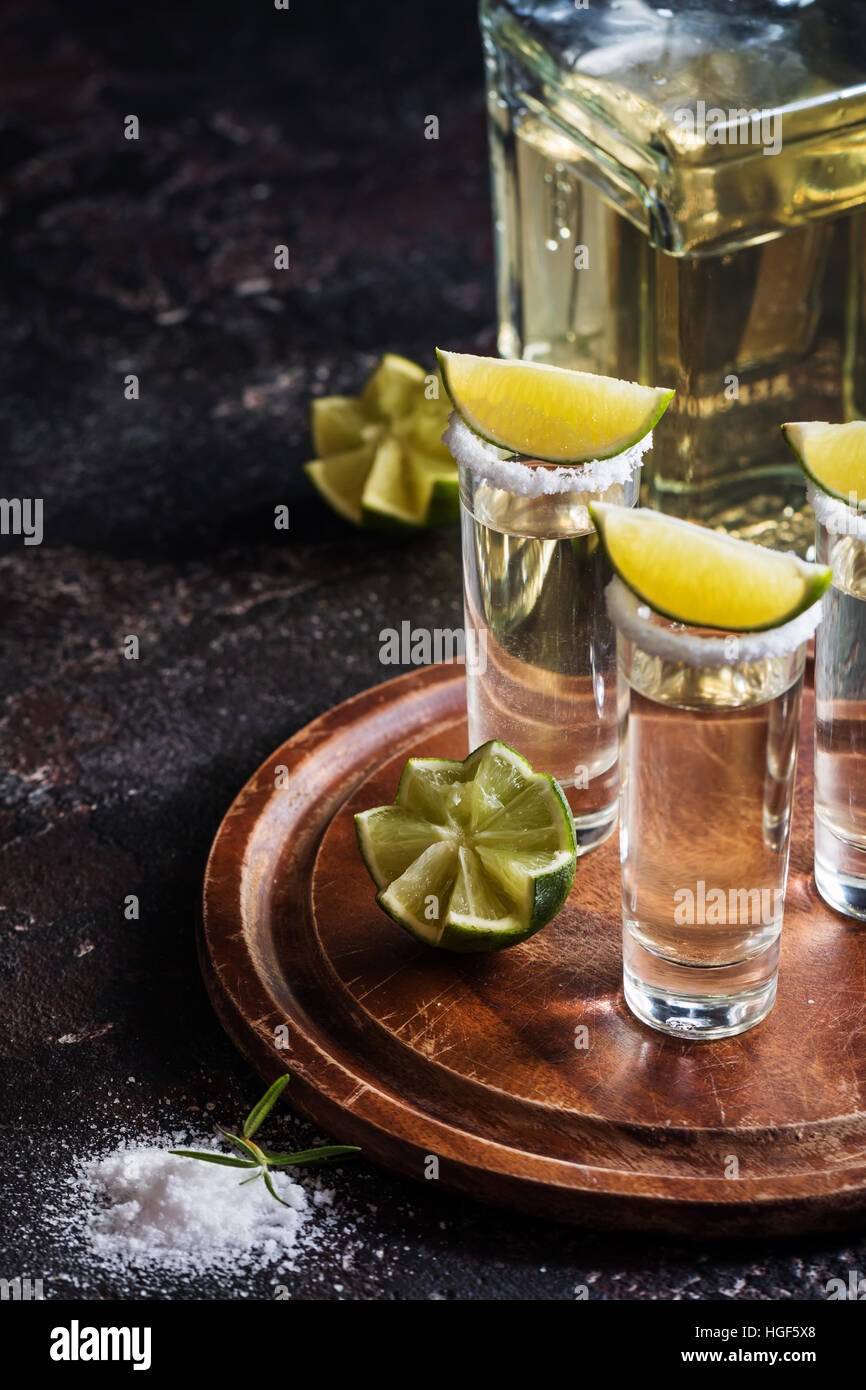 Mexican Gold Tequila with lime and salt on black background Stock Photo ...