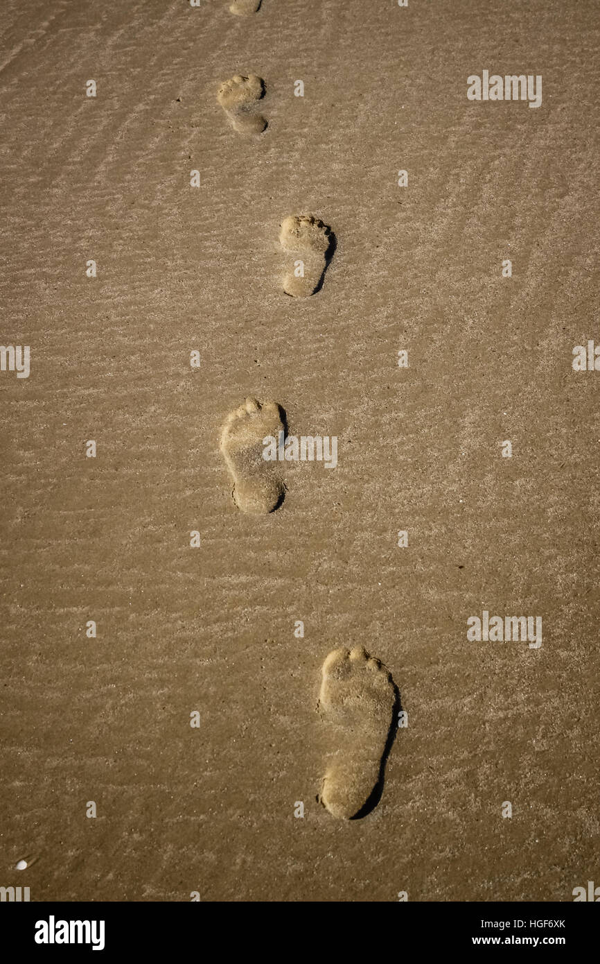 Footsteps in the sand on the beach Stock Photo - Alamy