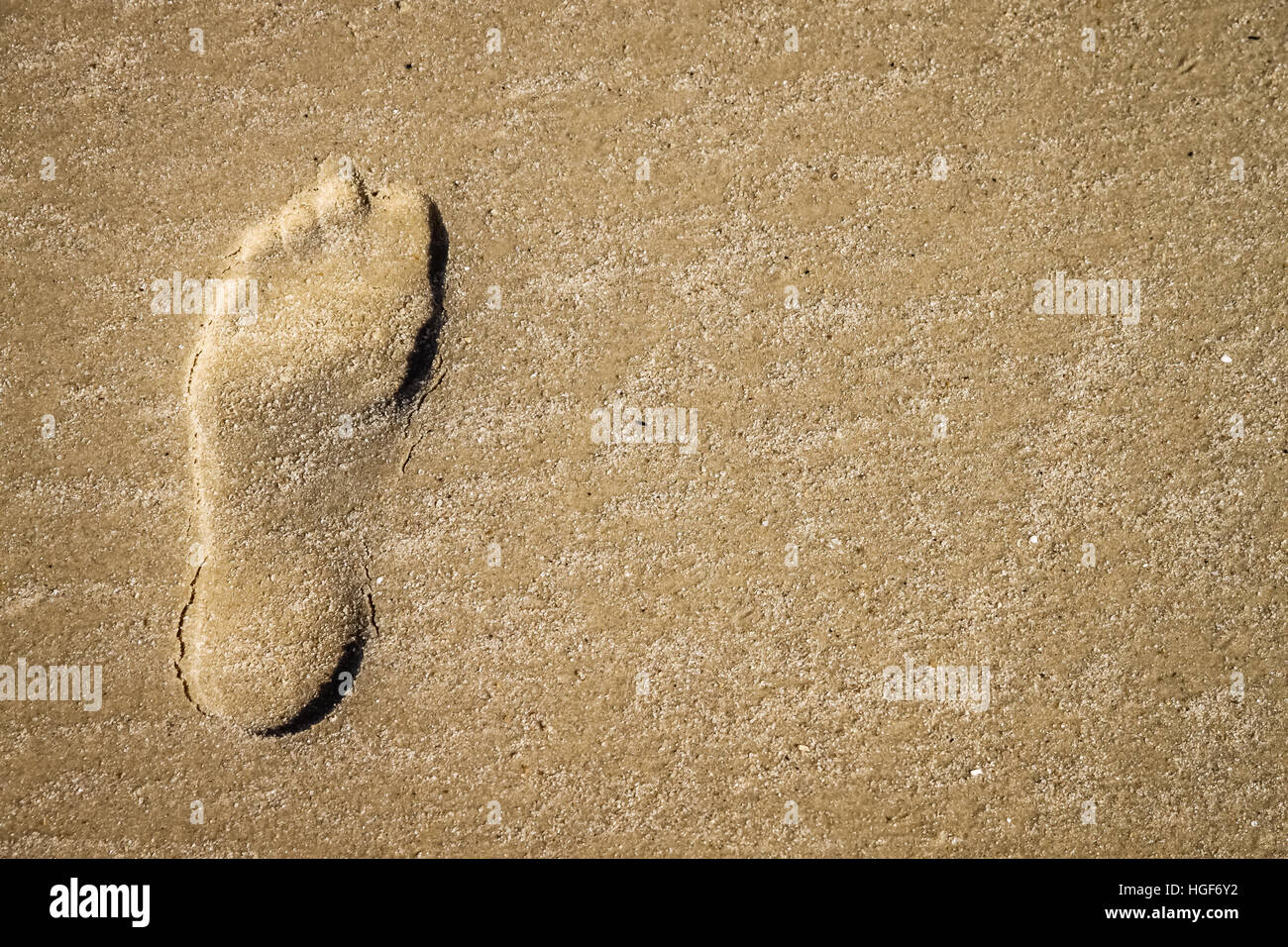 Footsteps in the sand on the beach Stock Photo - Alamy
