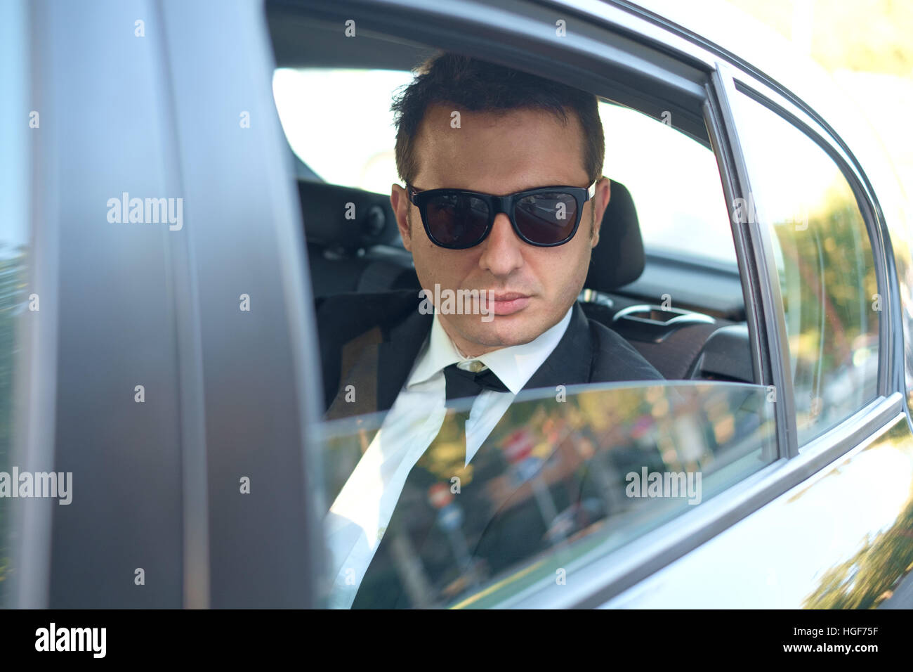 Businessman seated in a luxury car Stock Photo - Alamy