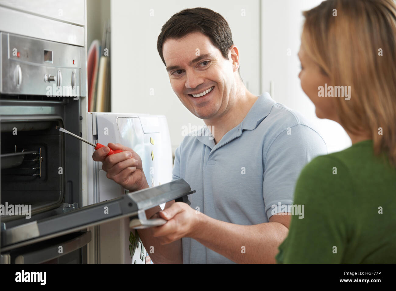 Engineer Giving Woman Advice On Kitchen Repair Stock Photo - Alamy