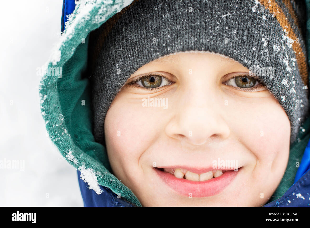 Happy Boy with Smiling Face Playing in Winter Snow Stock Photo - Alamy