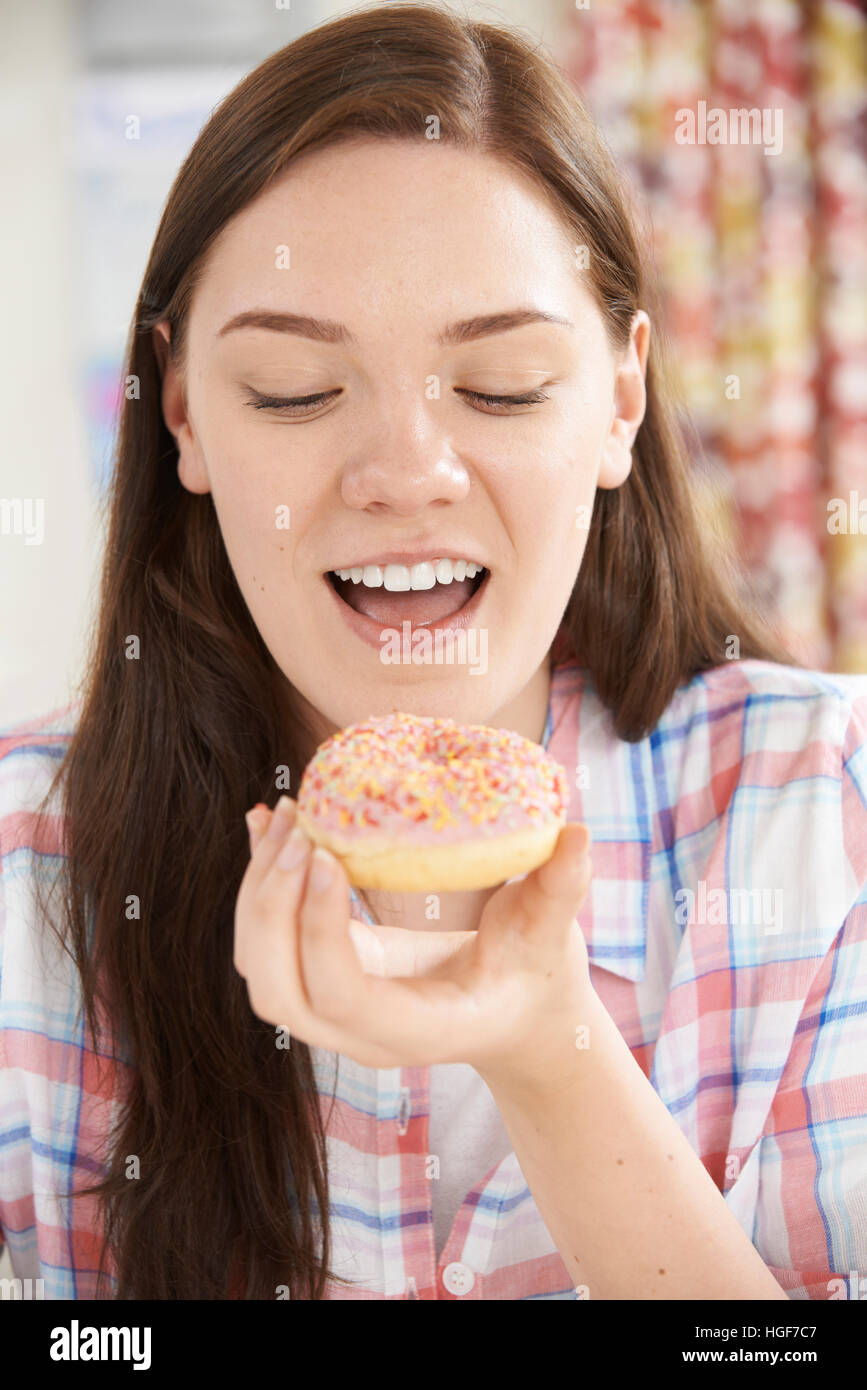 Smiling Teenage Girl On Eating Donut Stock Photo - Alamy