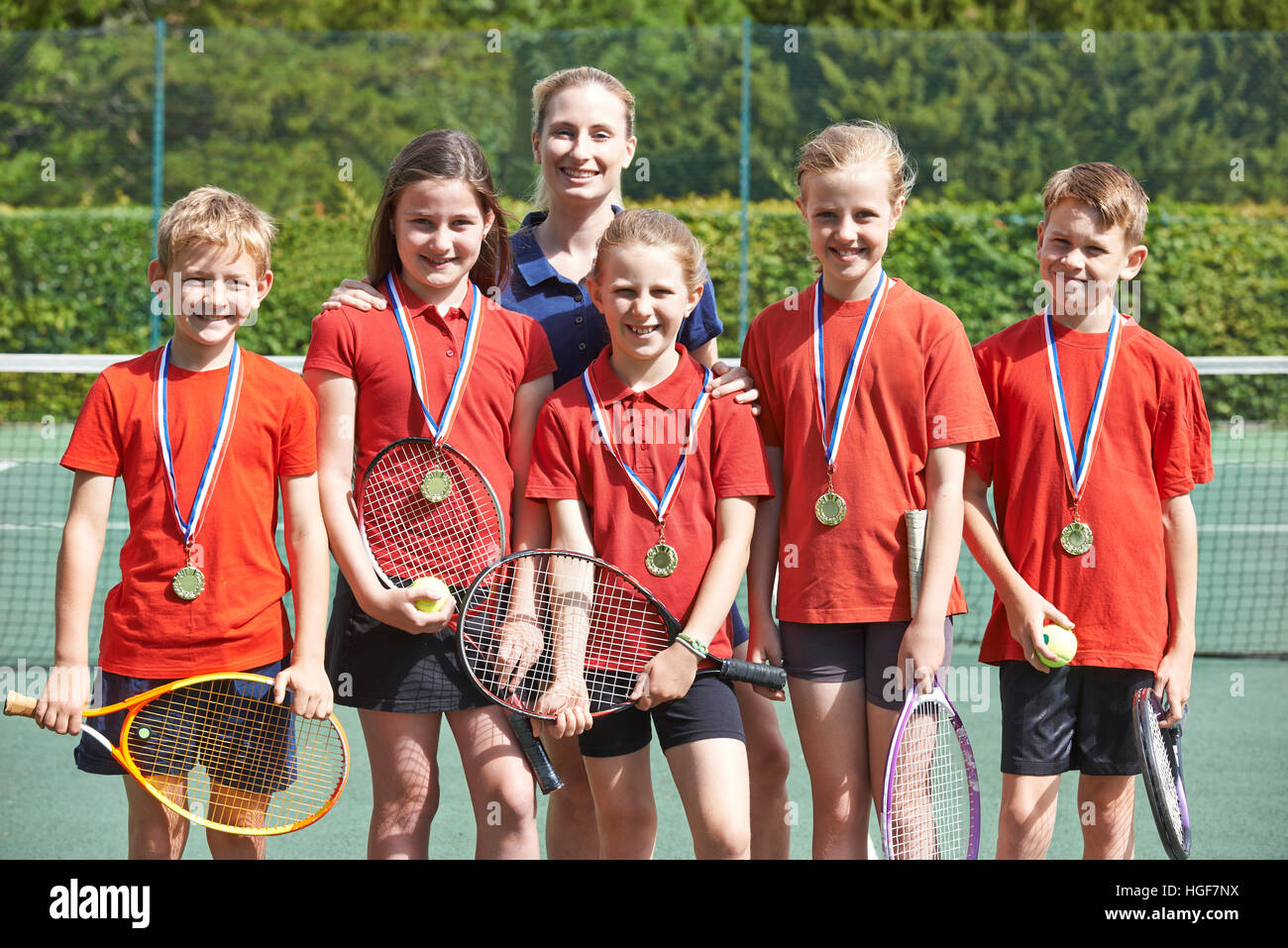 Victorious School Tennis Team With Medals Stock Photo - Alamy