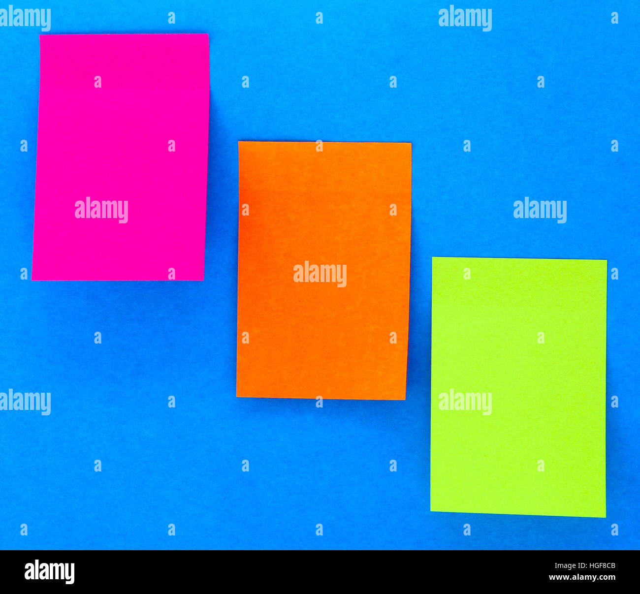 an empty color sticky notes on blue Stock Photo - Alamy