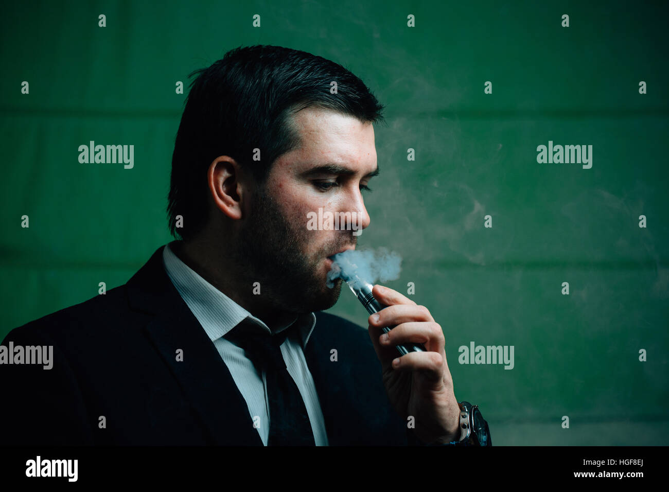 businessman smoking electronic cigarette Stock Photo - Alamy