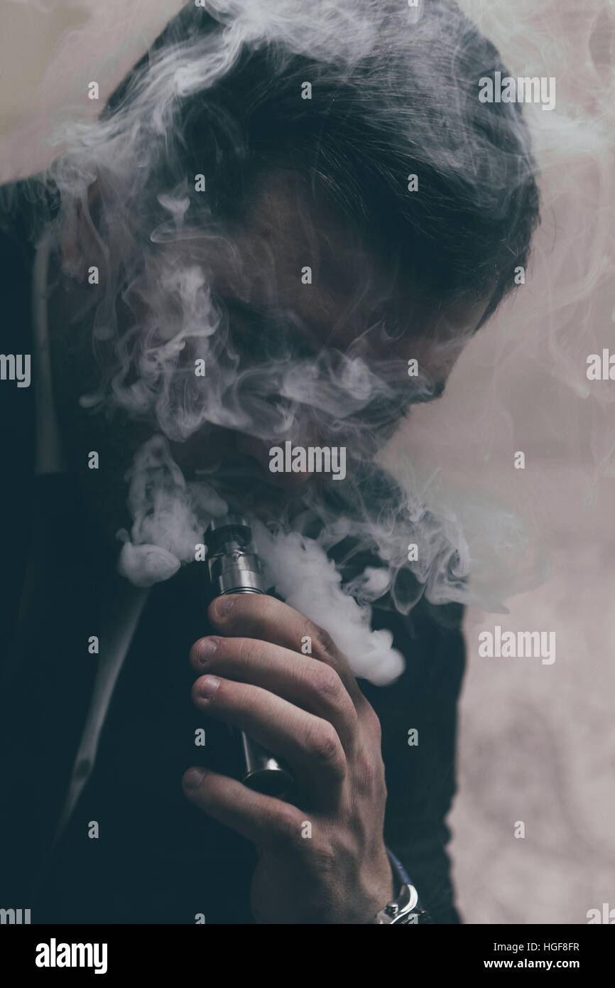 businessman smoking electronic cigarette Stock Photo - Alamy