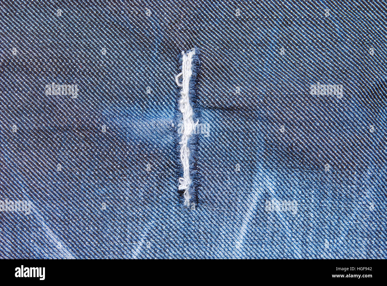 Hole on a jeans fabric Stock Photo - Alamy