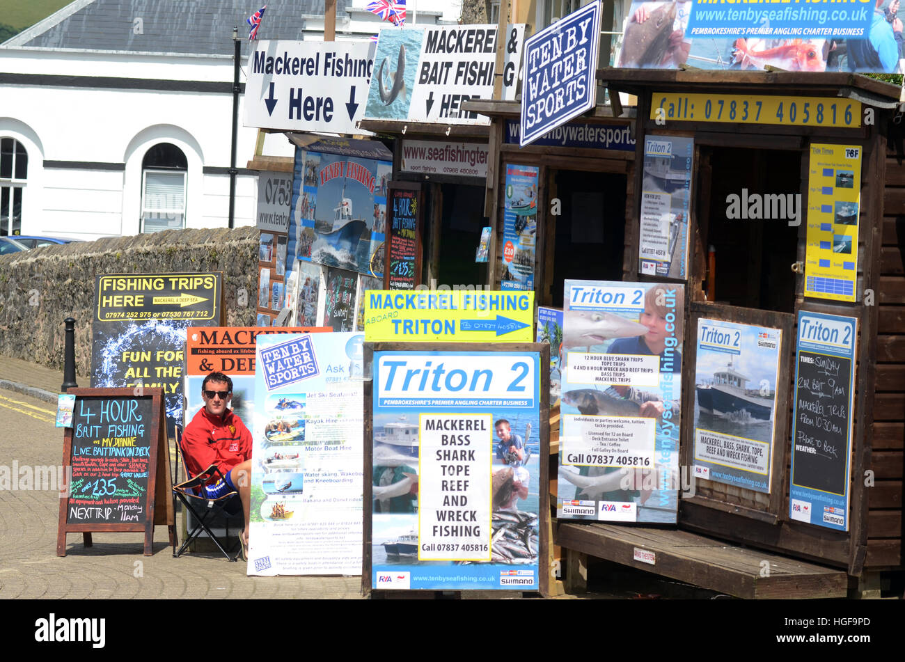 Boat trip signs and booths , Tenby Harbour Stock Photo - Alamy