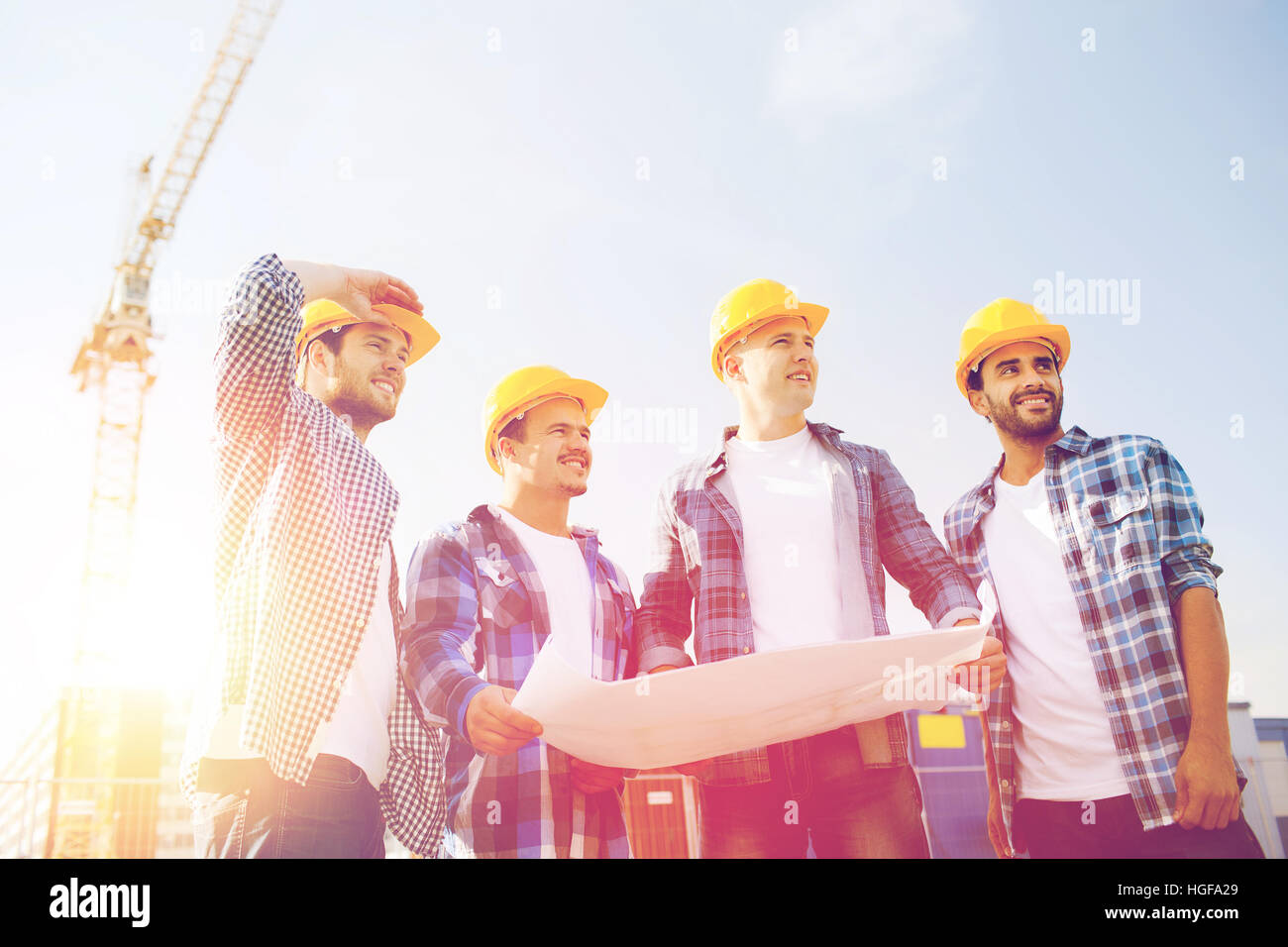 group of builders with tablet pc and blueprint Stock Photo - Alamy