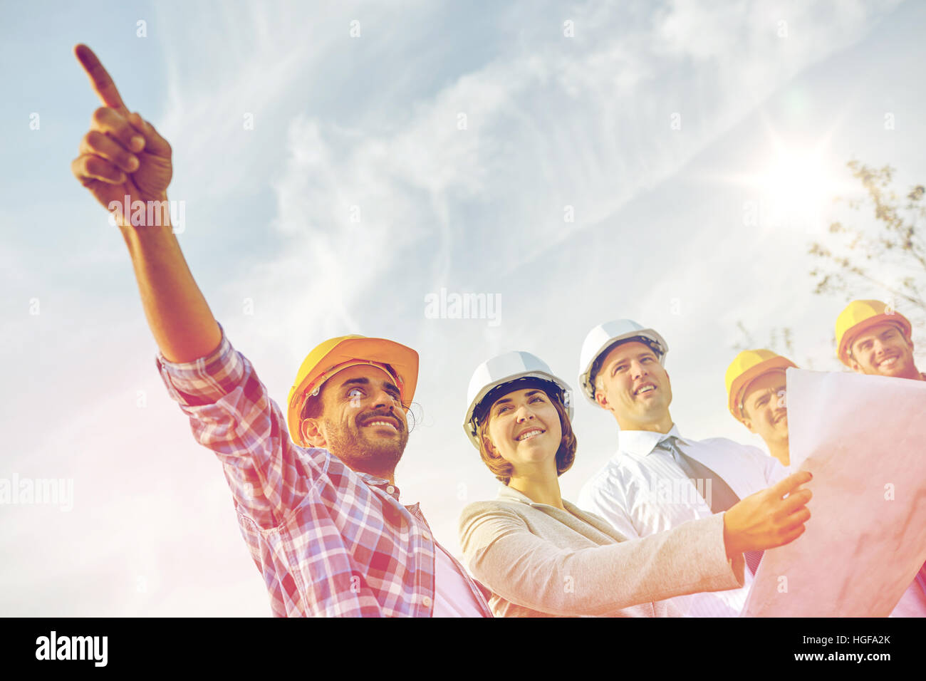 group of builders and architects with blueprint Stock Photo - Alamy