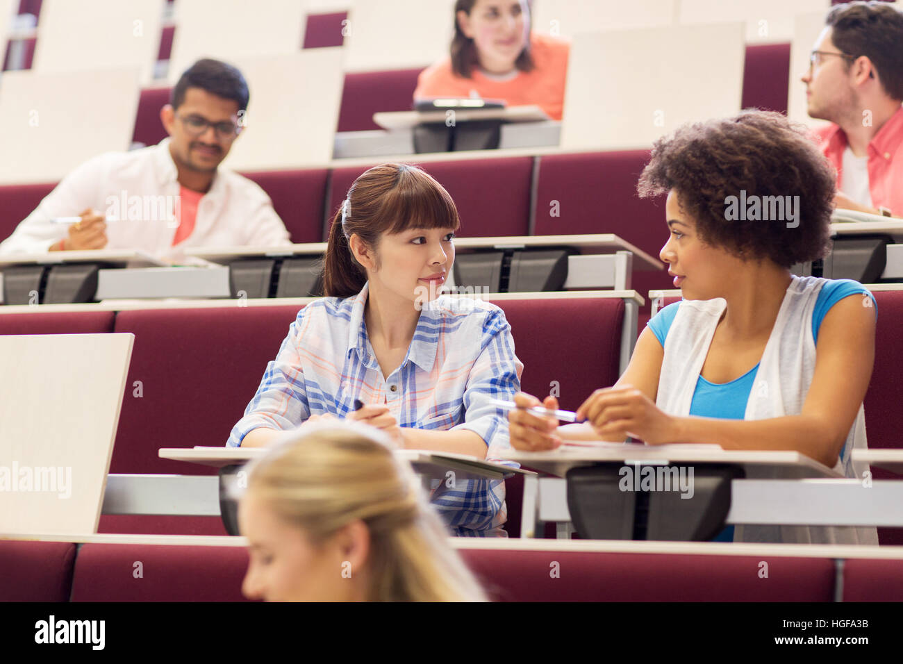 group of students talking in lecture hall Stock Photo - Alamy
