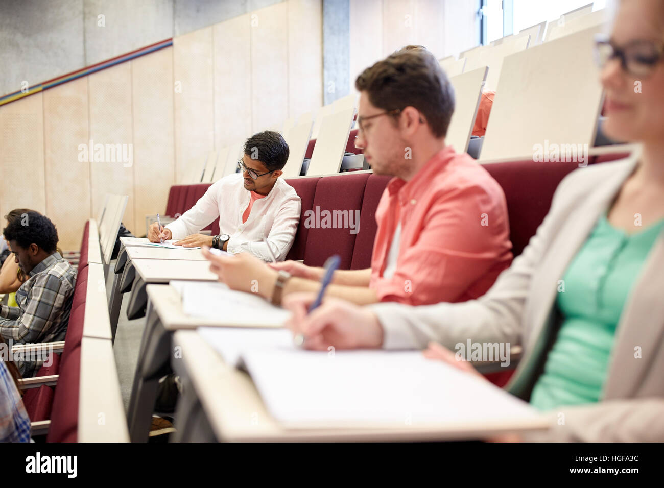 group of students with notebooks in lecture hall Stock Photo - Alamy