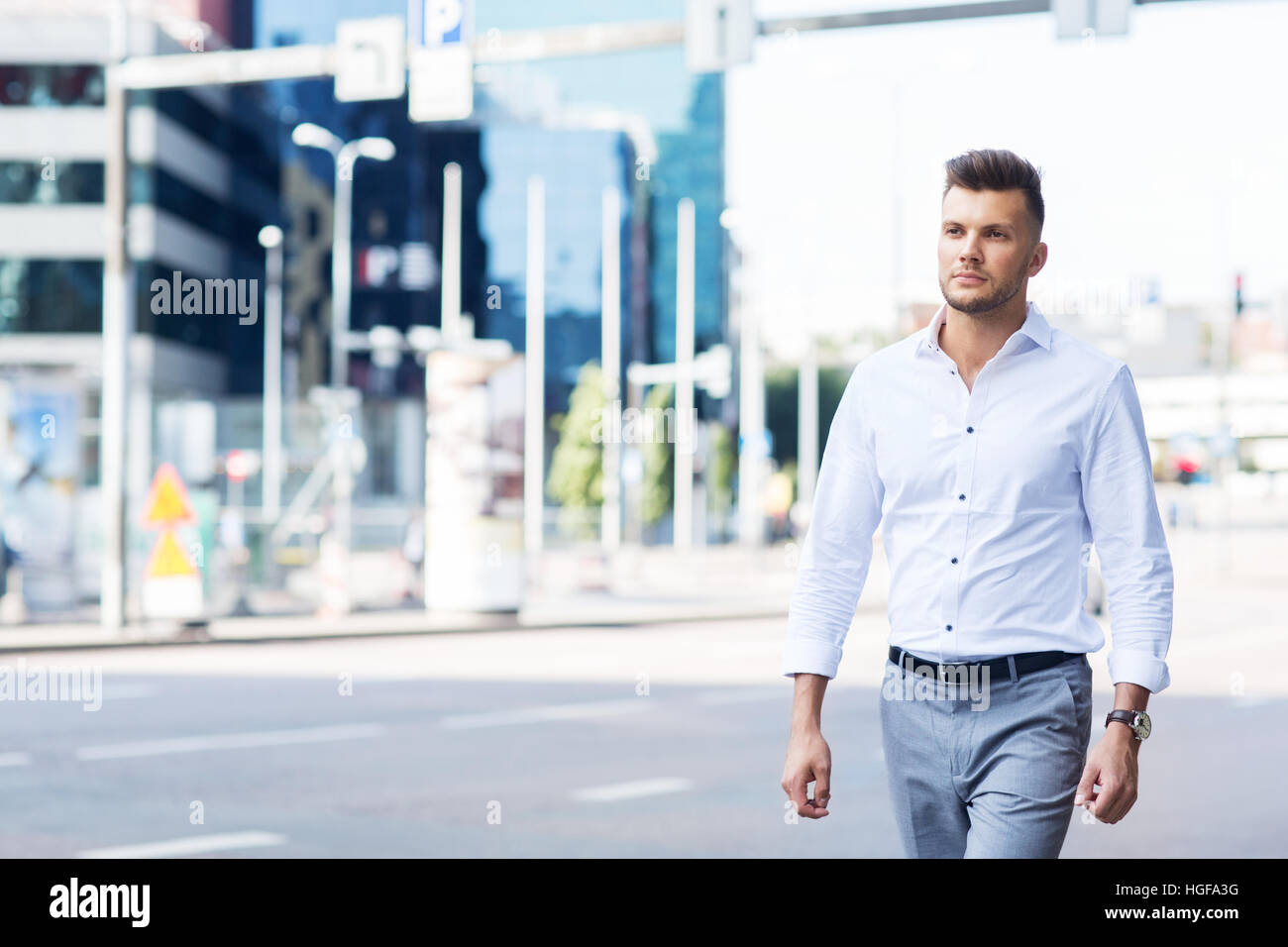 Young man walking the city hi-res stock photography and images - Alamy