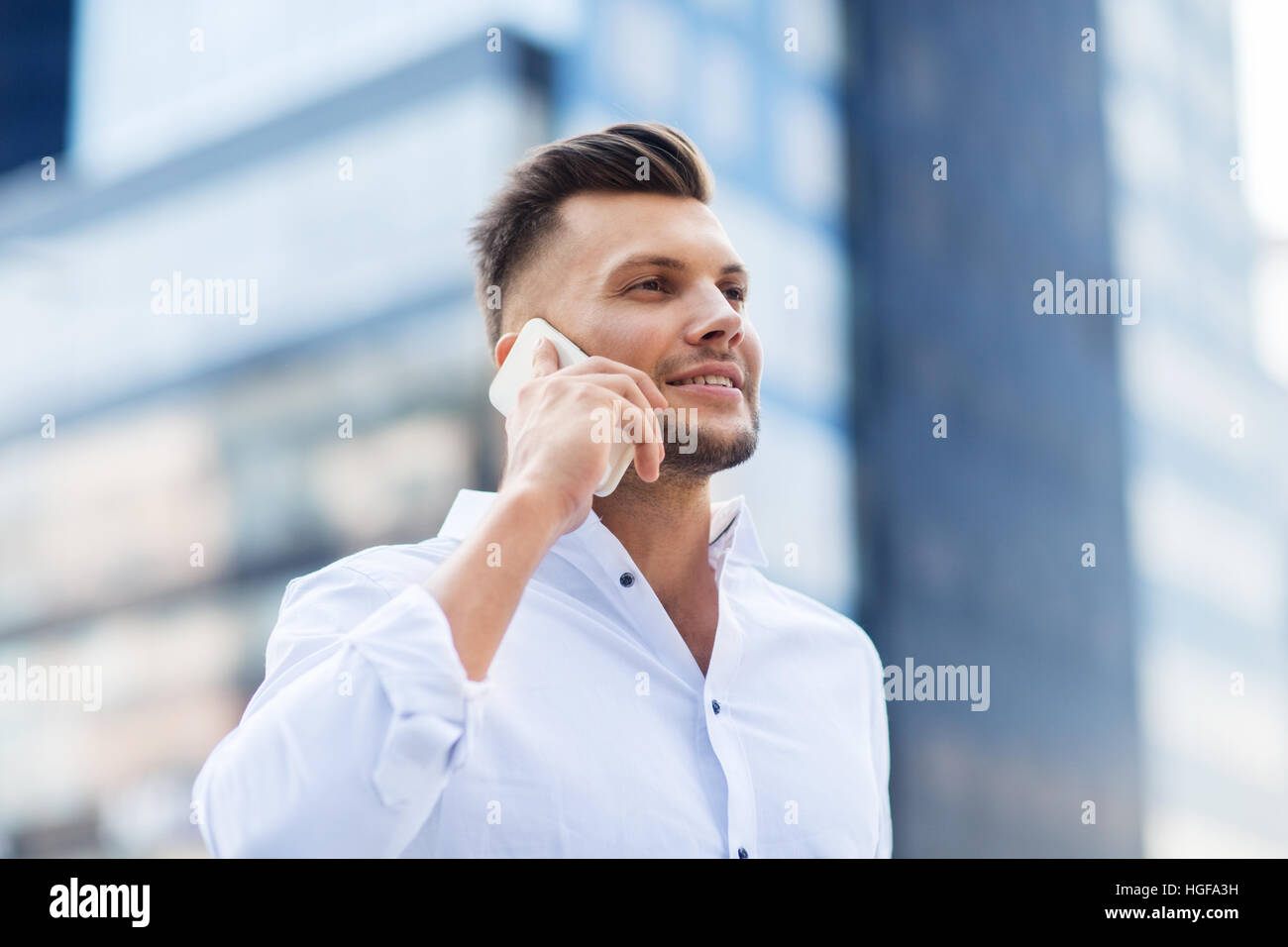 happy man with smartphone calling on city street Stock Photo - Alamy