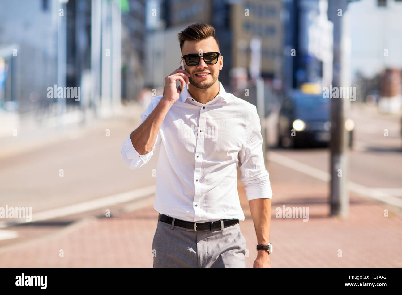 happy man with smartphone calling on city street Stock Photo - Alamy