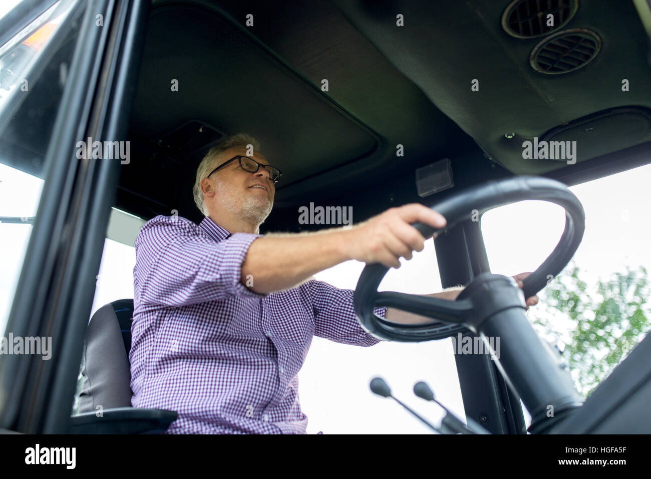 senior man driving tractor at farm Stock Photo - Alamy