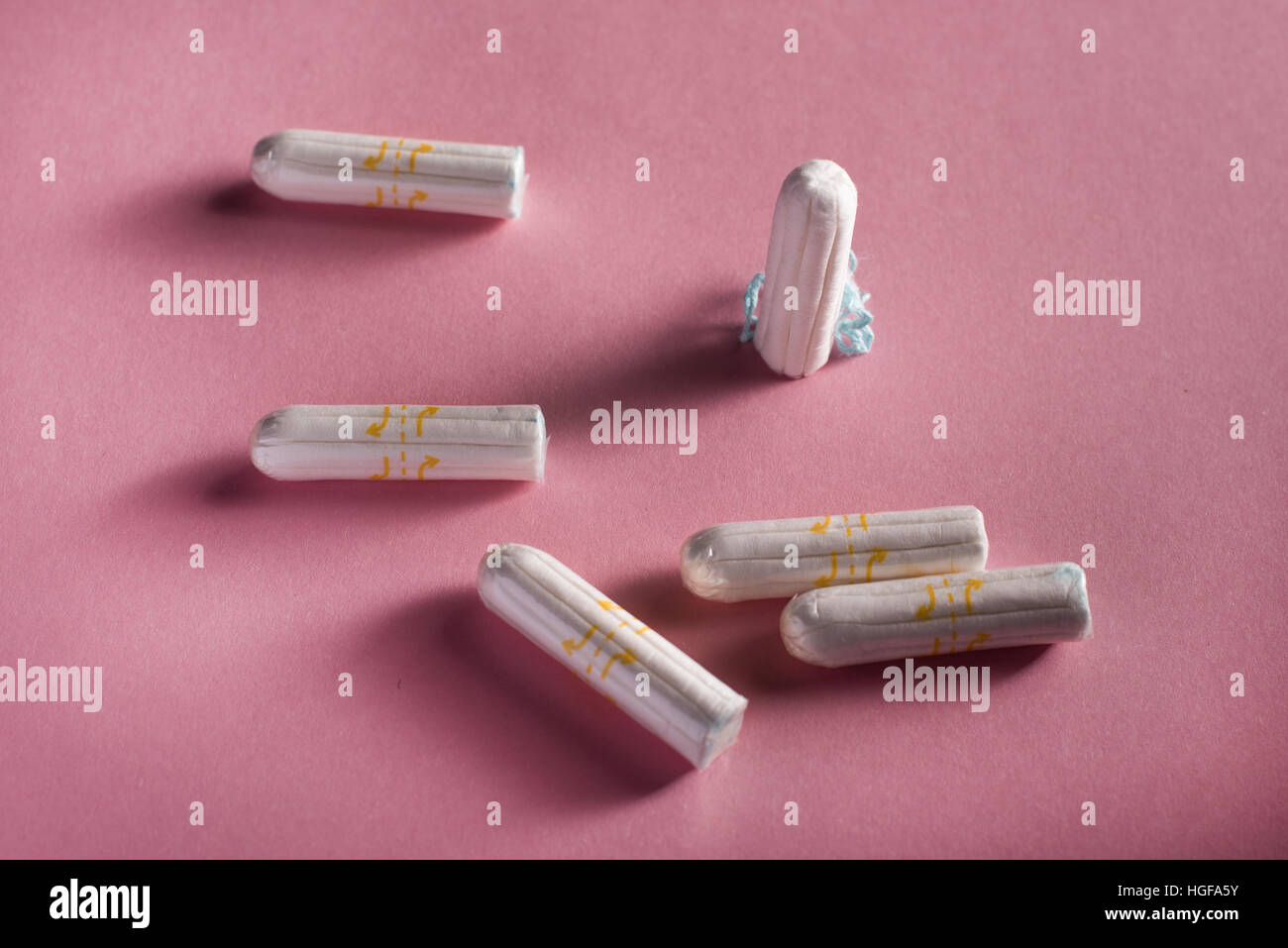 Clean white tampons on pink background Stock Photo - Alamy