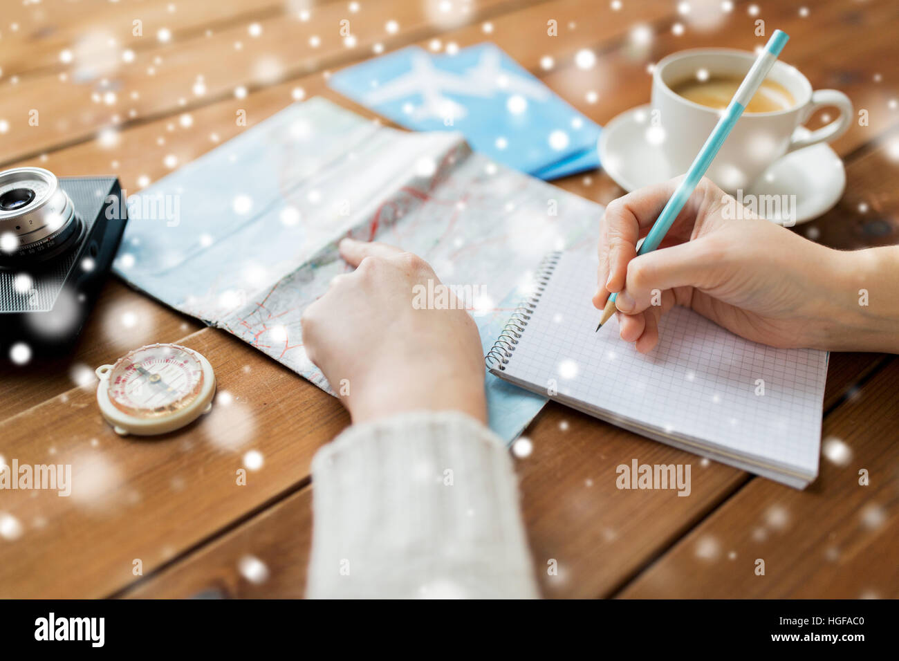 hands with map and coffee writing to notebook Stock Photo - Alamy