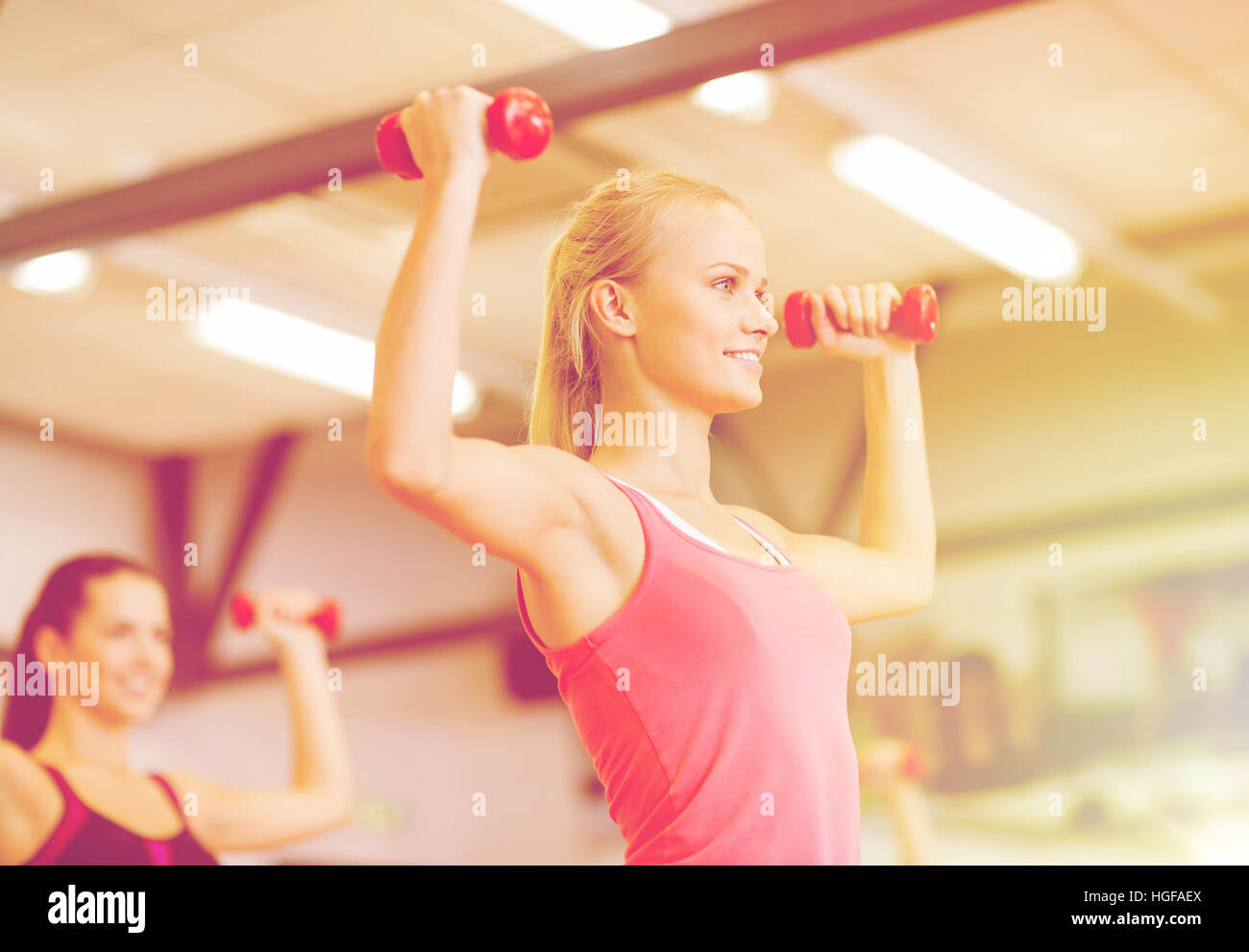 group of smiling people working out with dumbbells Stock Photo - Alamy
