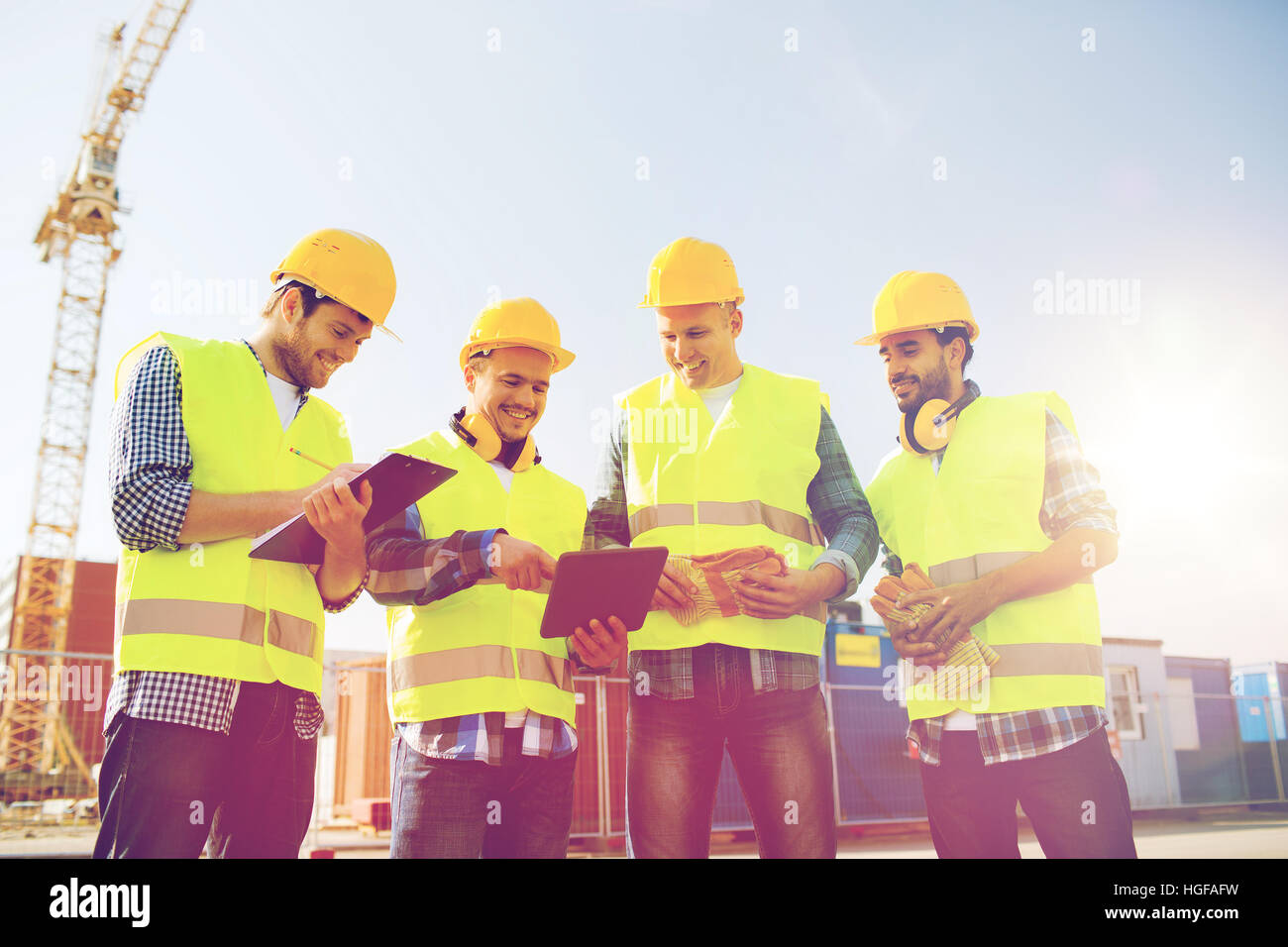 group of smiling builders with tablet pc outdoors Stock Photo - Alamy