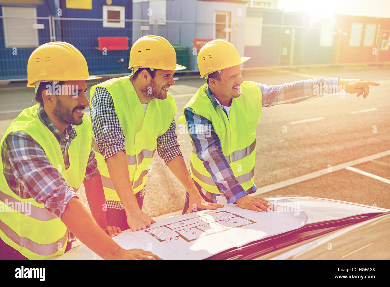 close up of builders with blueprint on car hood Stock Photo - Alamy