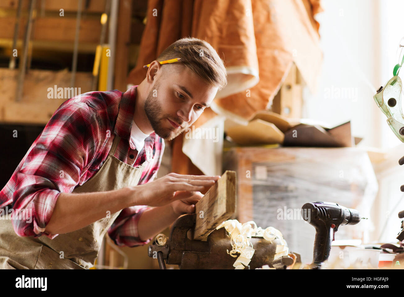 carpenter working with wood plank at workshop Stock Photo - Alamy