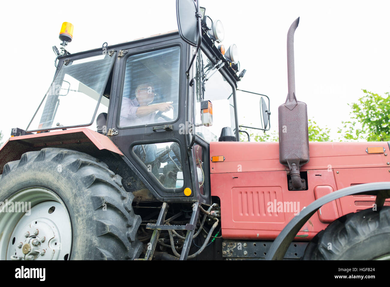 senior man driving tractor at farm Stock Photo - Alamy