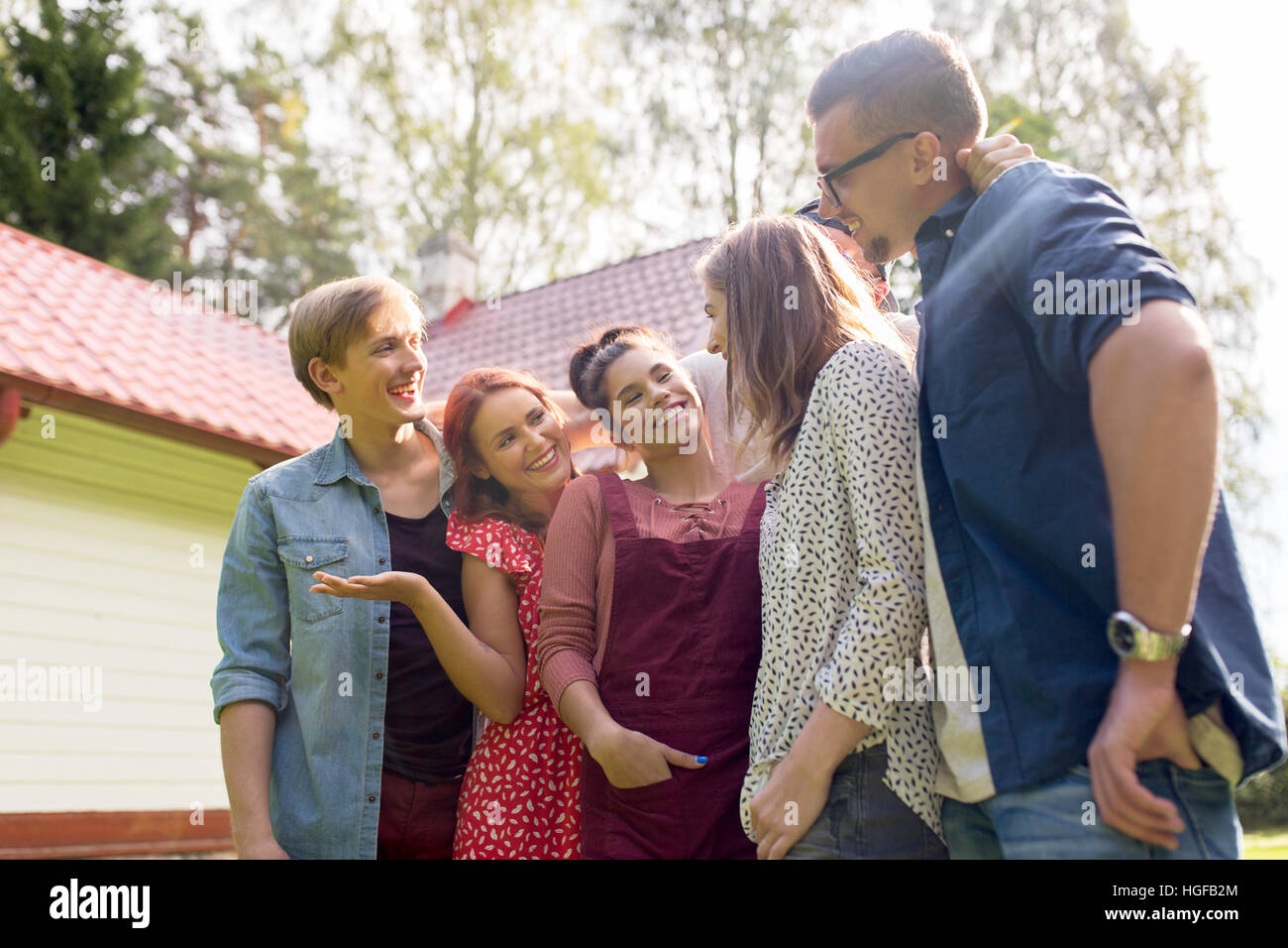 happy teenage friends talking at summer garden Stock Photo - Alamy