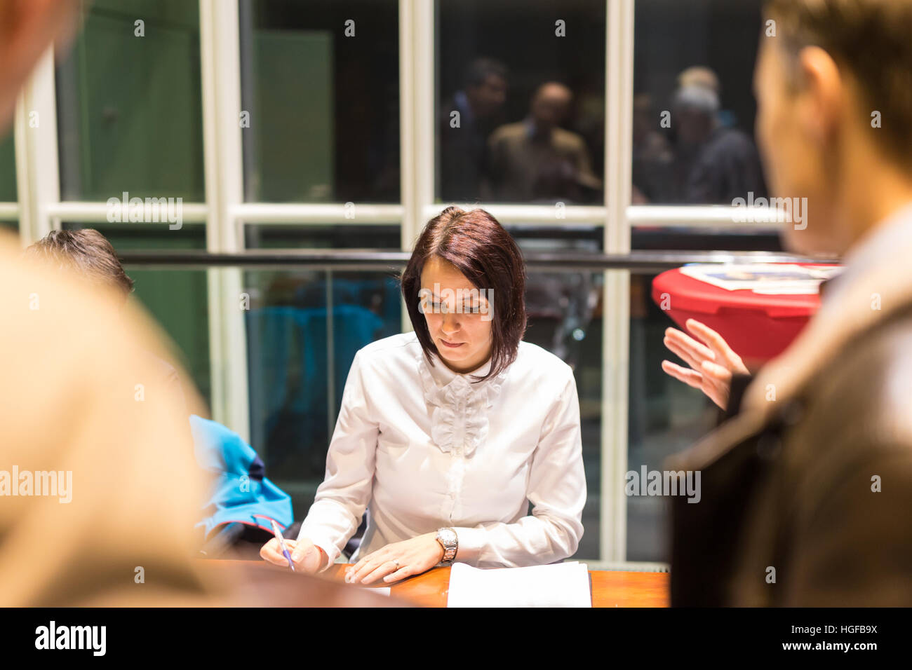 Personal assistant working at registration desk at corporate event ...