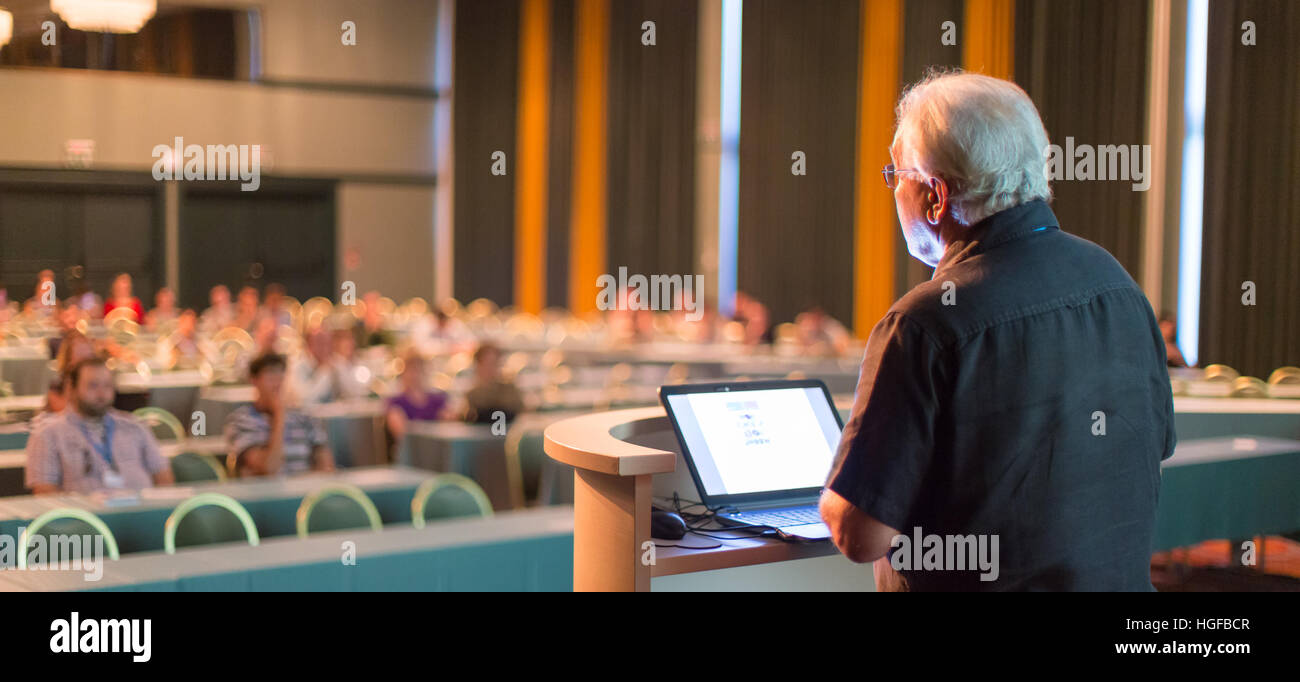 Senior public speaker giving talk at scientific conference Stock Photo ...