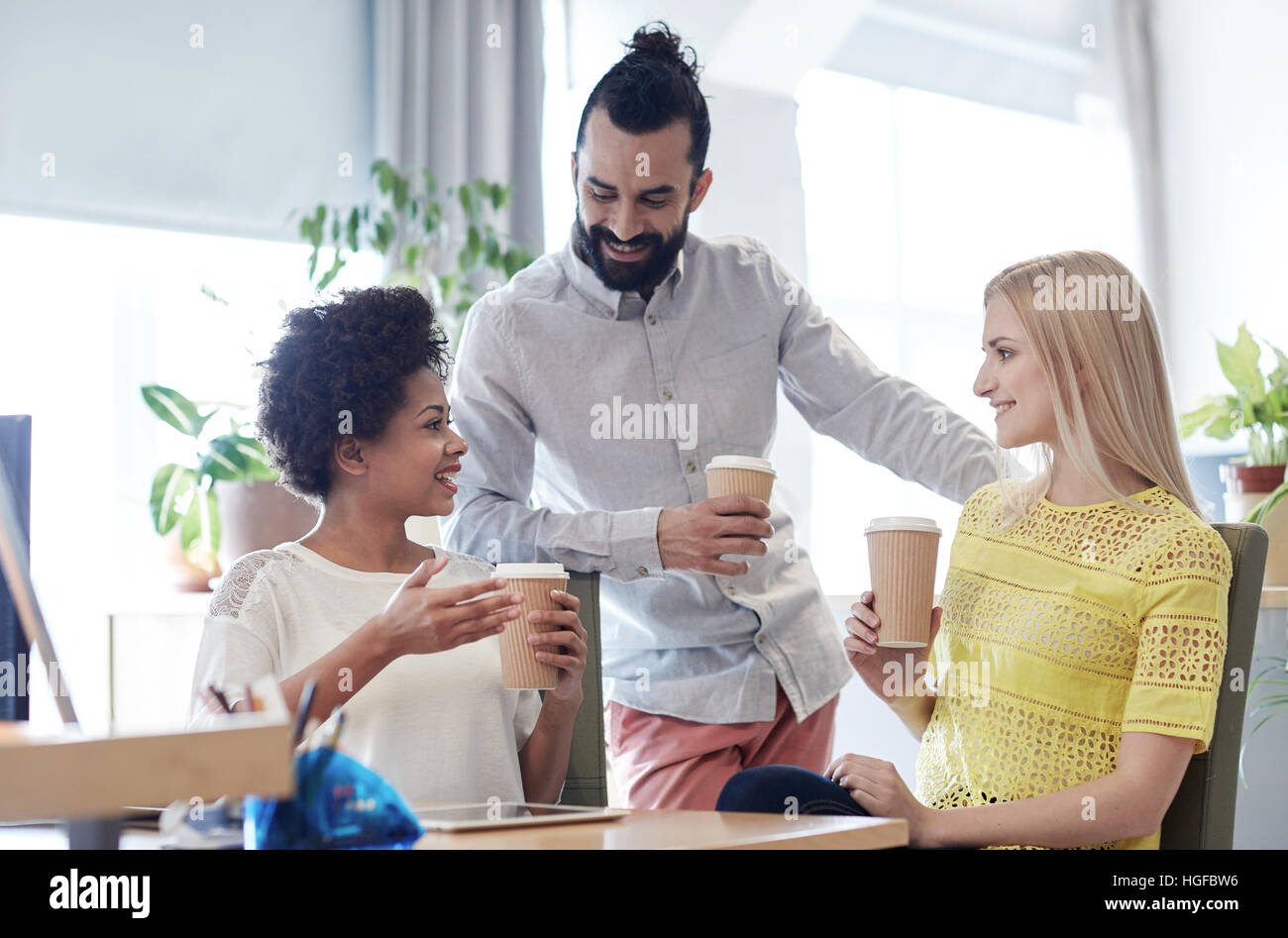 happy creative team drinking coffee in office Stock Photo - Alamy