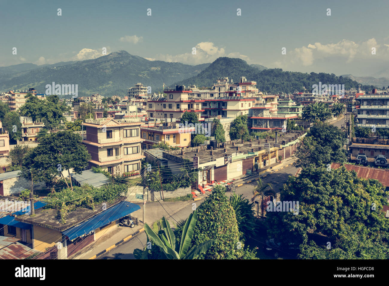 Rooftop view of mountains rising in distance Stock Photo - Alamy