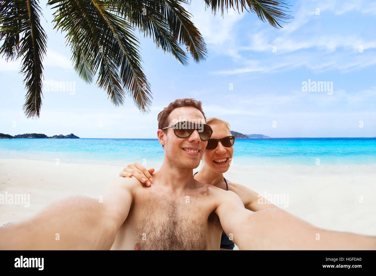 happy young couple taking selfie photo on the beach, self portrait or ...