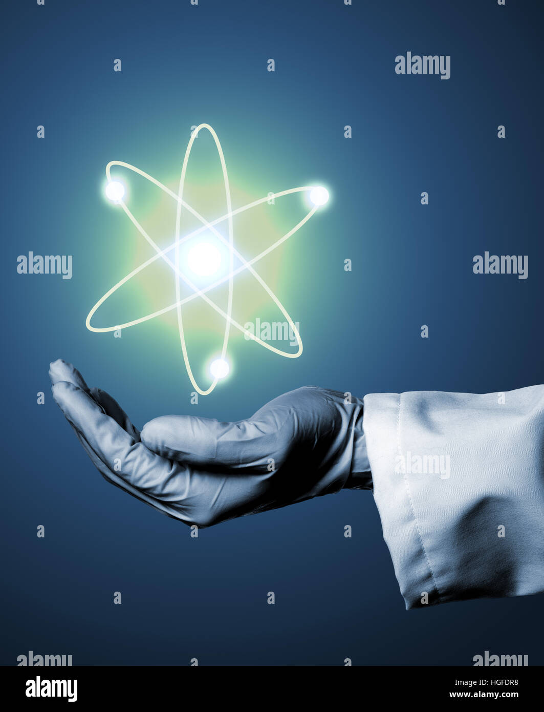 Researcher or scientist with rubber glove holding glowing atom model on ...