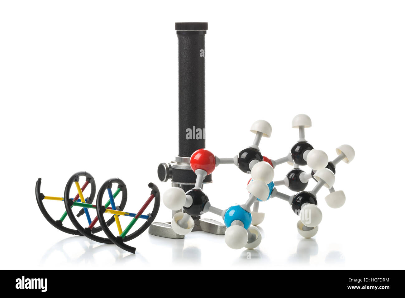 Chemical molecule and DNA structure model with old microscope over ...