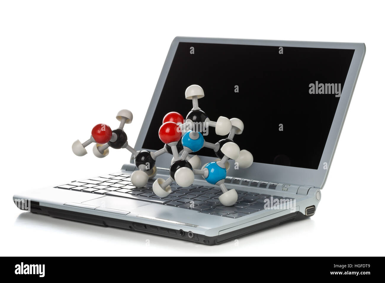 Ball and stick chemical molecule model on laptop computer keyboard over ...