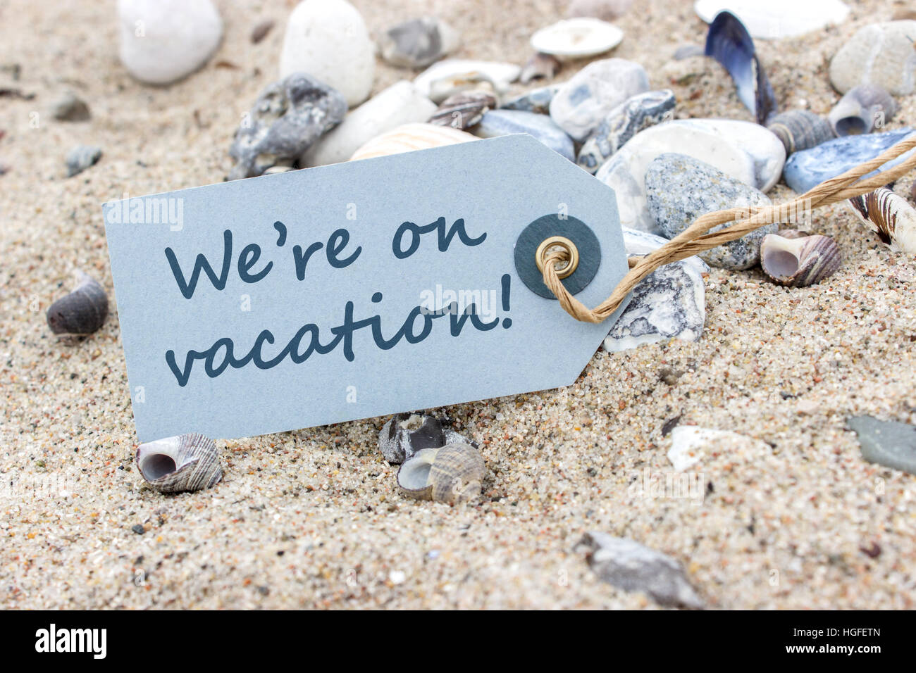Card with the text "We're on vacation" in beach sand Stock Photo - Alamy