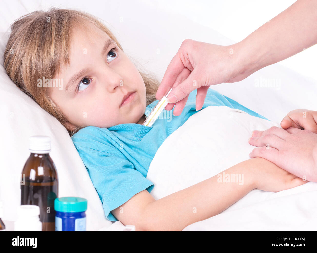 Sick little girl in bed Stock Photo - Alamy