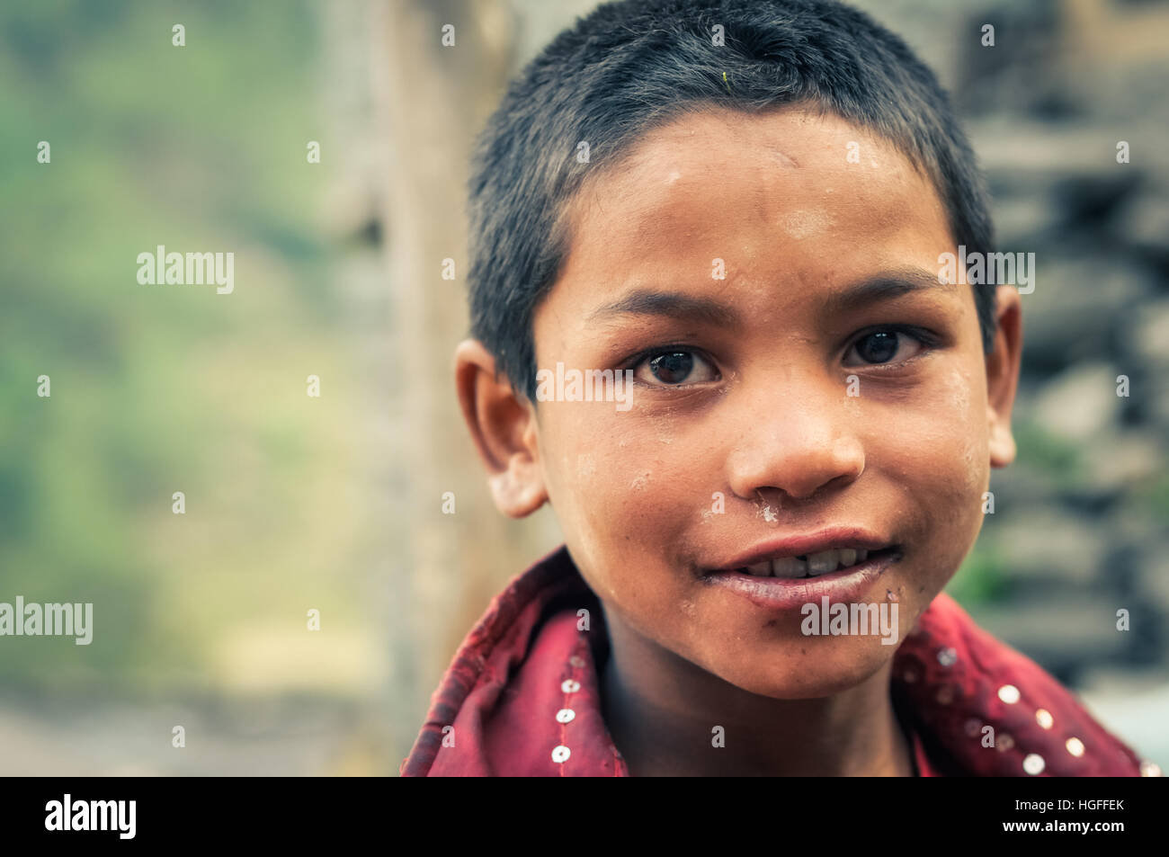 Beni, Nepal - circa May 2012: Young native boy with big brown eyes and ...