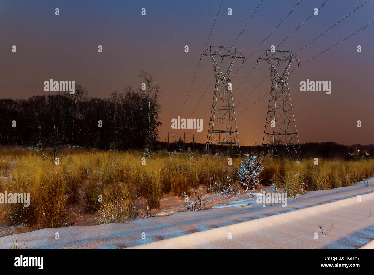 Industrial landscape - illuminated railway station by winter night with ...