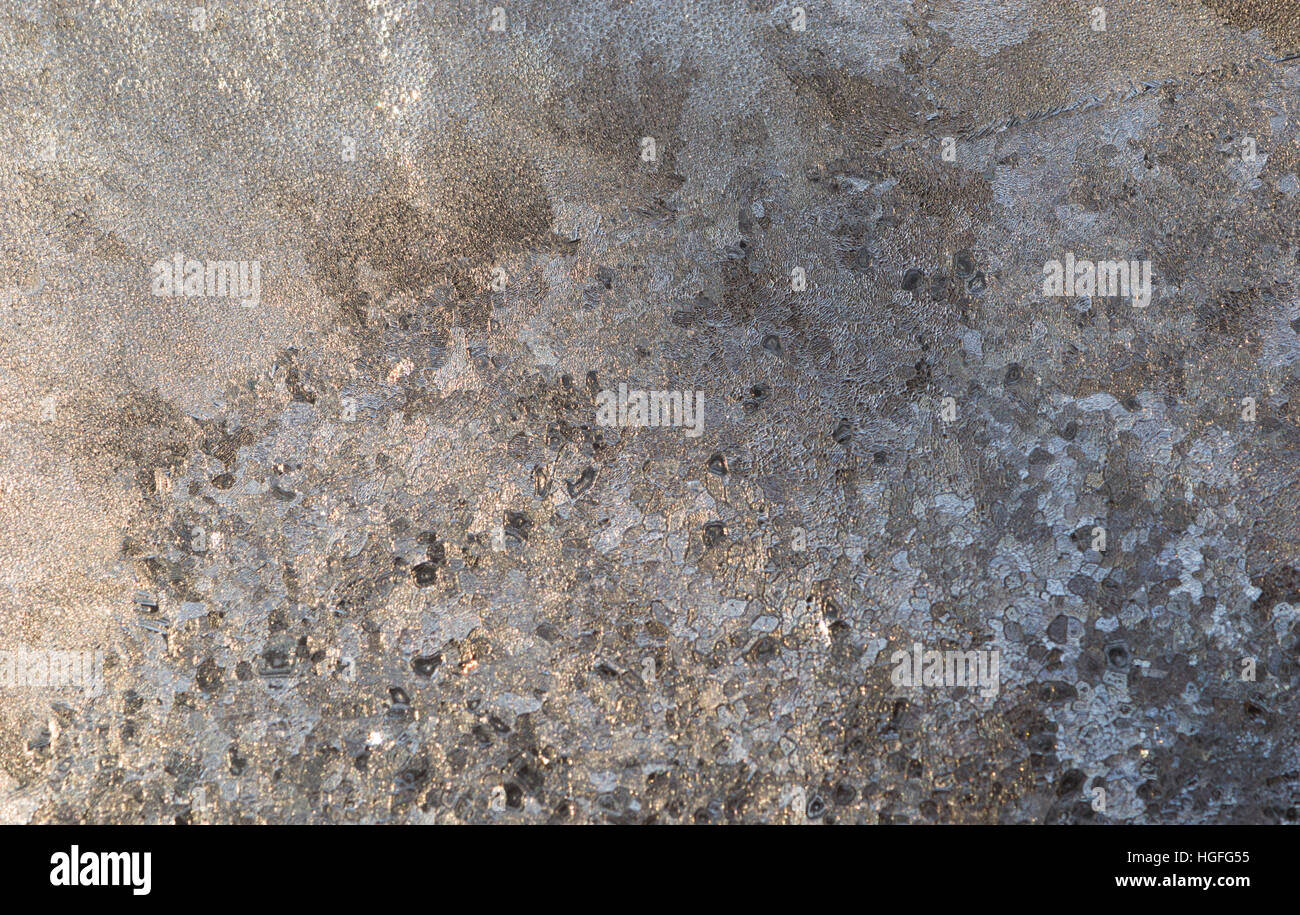 Close up of ice crystals with pebbled or cobblestone texture on window ...