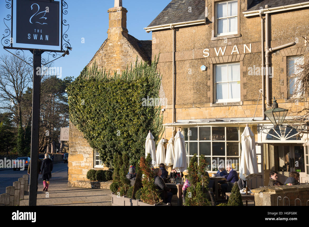Swan Inn with outside diners, Broadway village in the Cotswolds on a ...