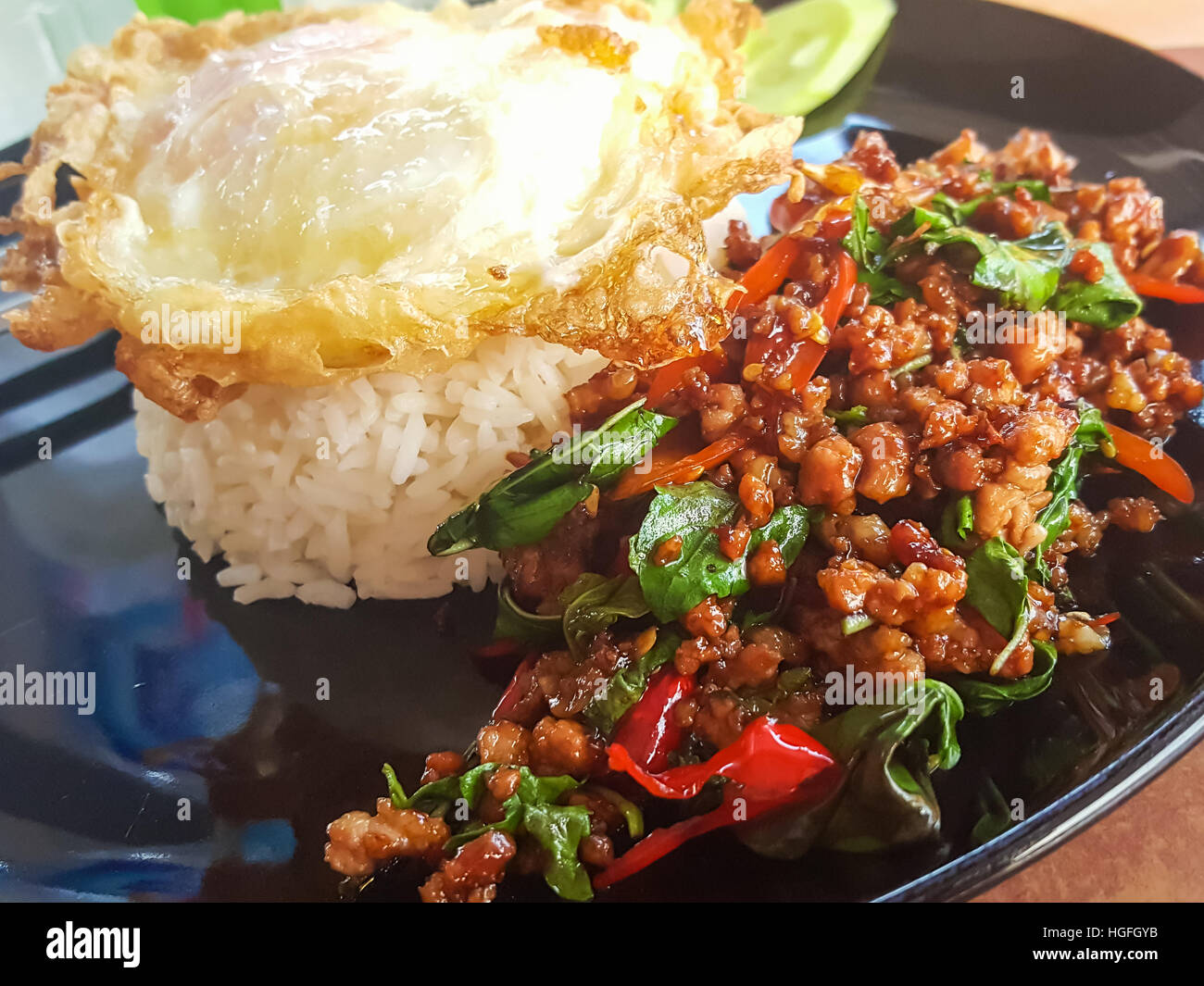 Kao Pad Kra Prao or Thai rice with pork and basil Stock Photo - Alamy