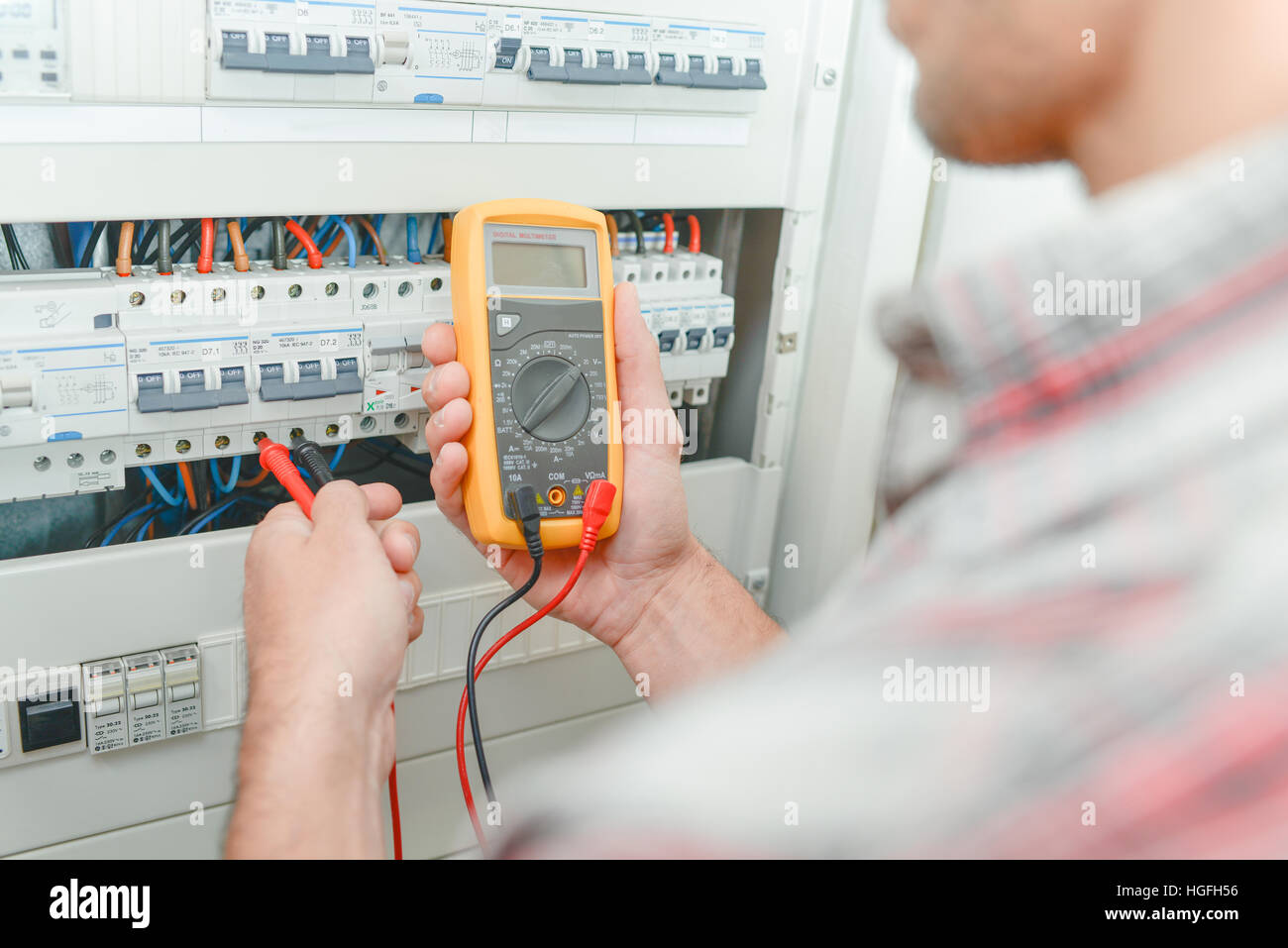 Electrician using multimeter Stock Photo - Alamy